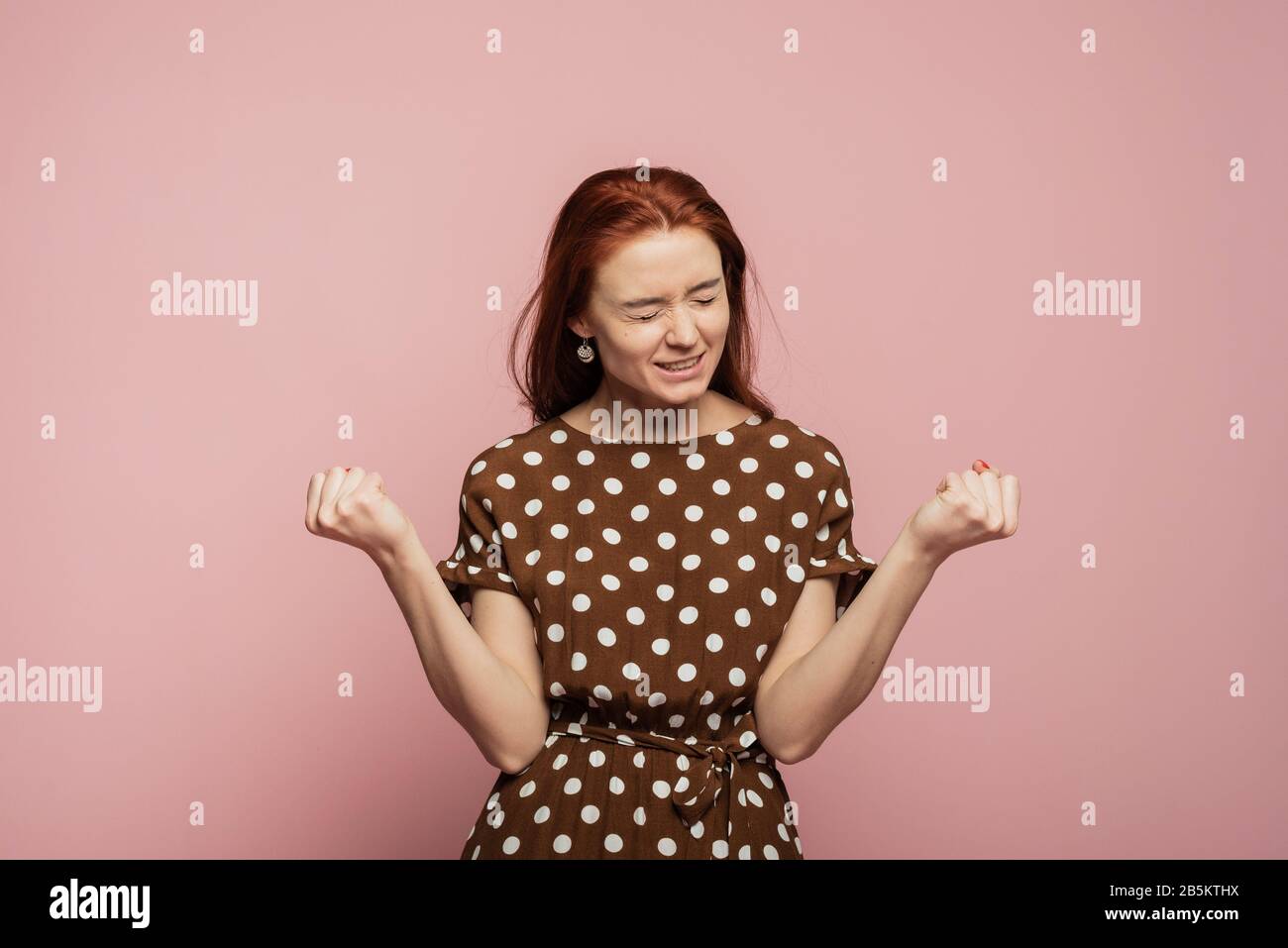 A sweet and beautiful woman experiences a strong emotion of joy and ...