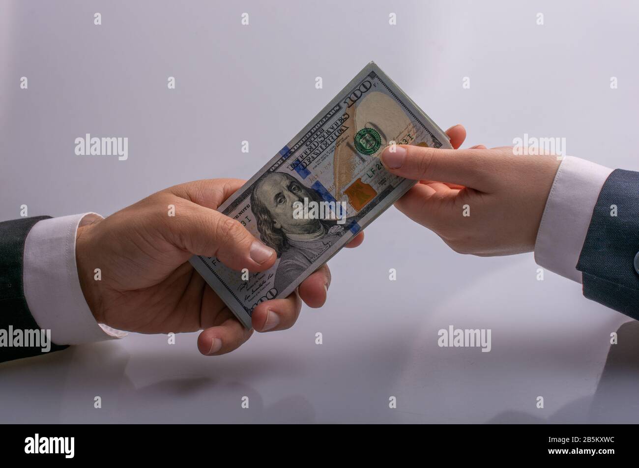 Businessman giving and receiving US dollar banknote money Stock Photo ...