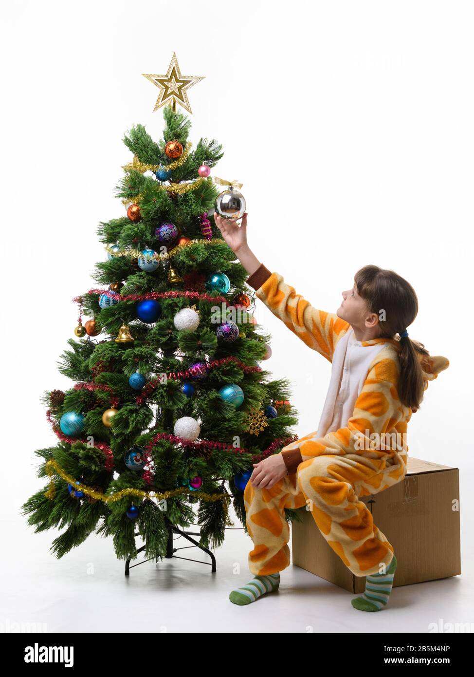 Teen girl sits in tree hi-res stock photography and images - Alamy