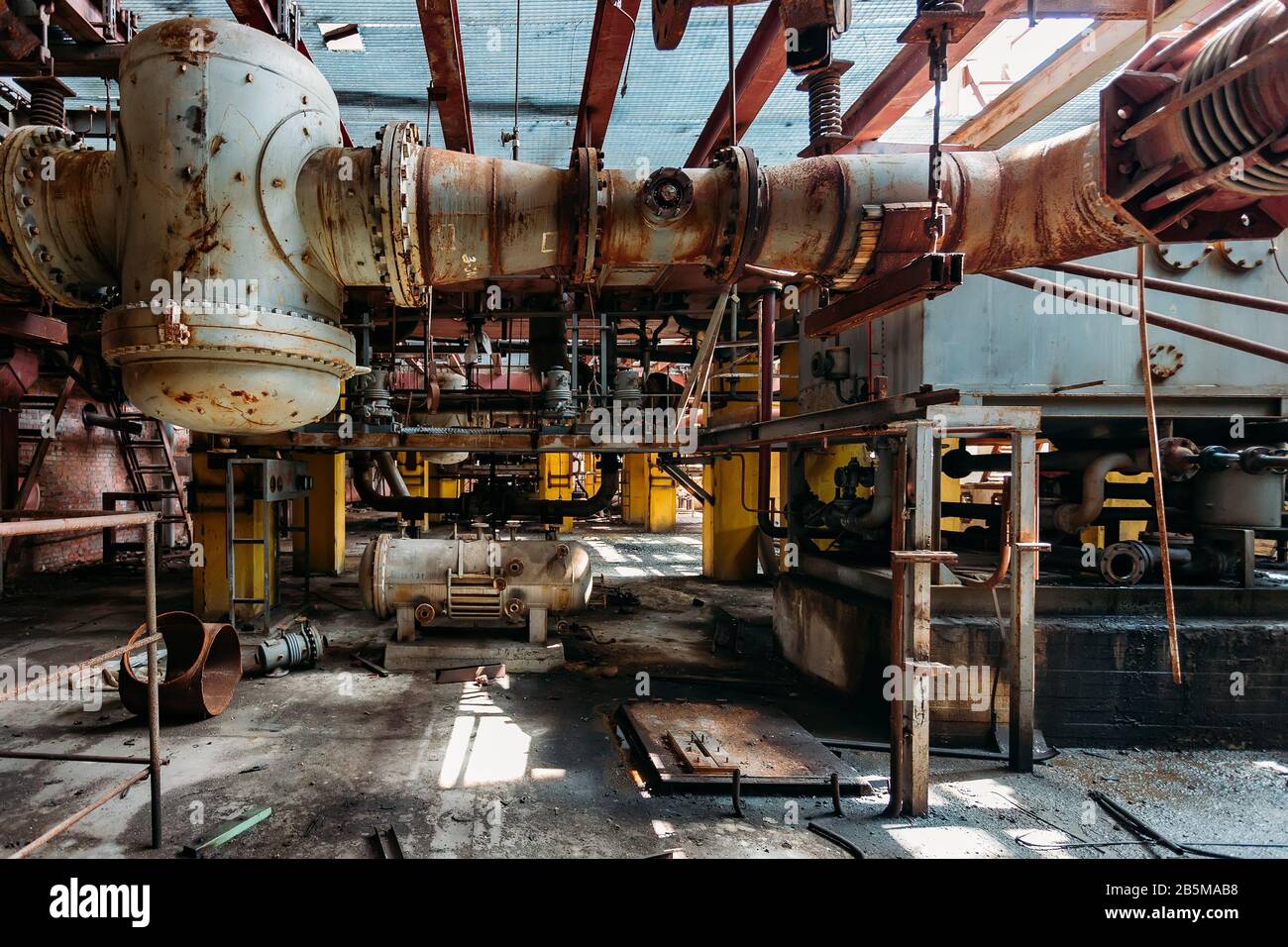 Old rusty Industrial tanks connected by pipes connected with valves in ...