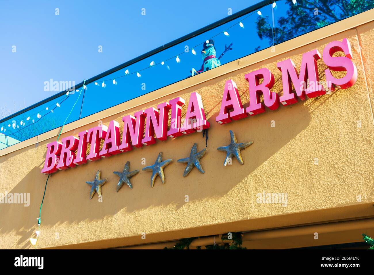 Britannia Arms sign at pub and restaurant. Christmas light and snowman ...