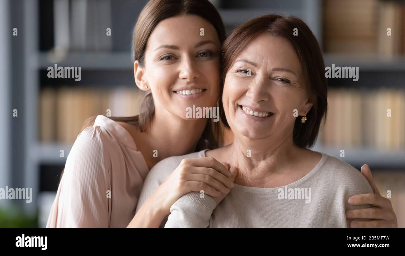 Portrait young affectionate woman cuddling older senior mother Stock ...