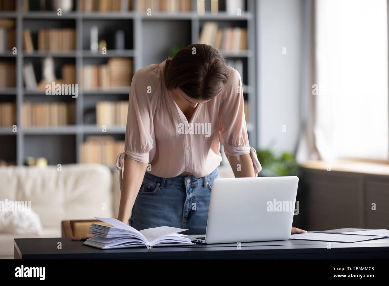 Overwhelmed frustrated young woman stand with bowed head Stock Photo ...