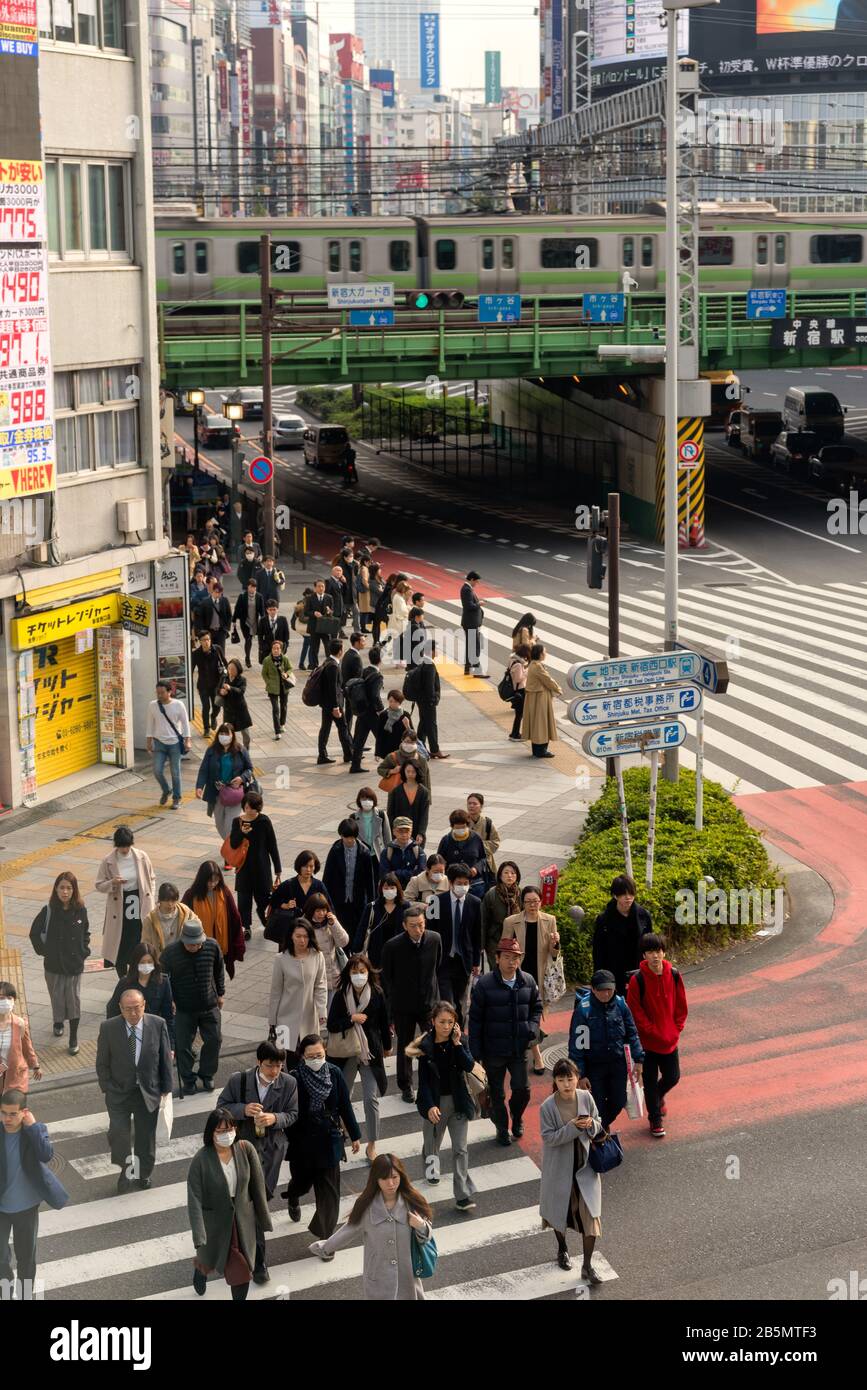 Commuters walking to work,Shinjuku,Tokyo, Japan with commuter train in ...