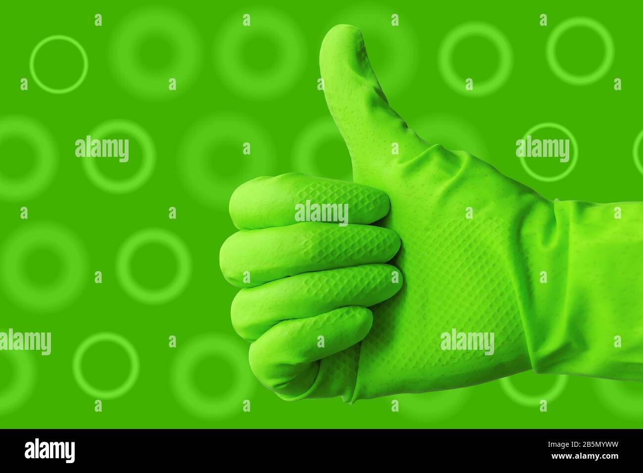 Hand in green protective rubber glove on green background with dots ...