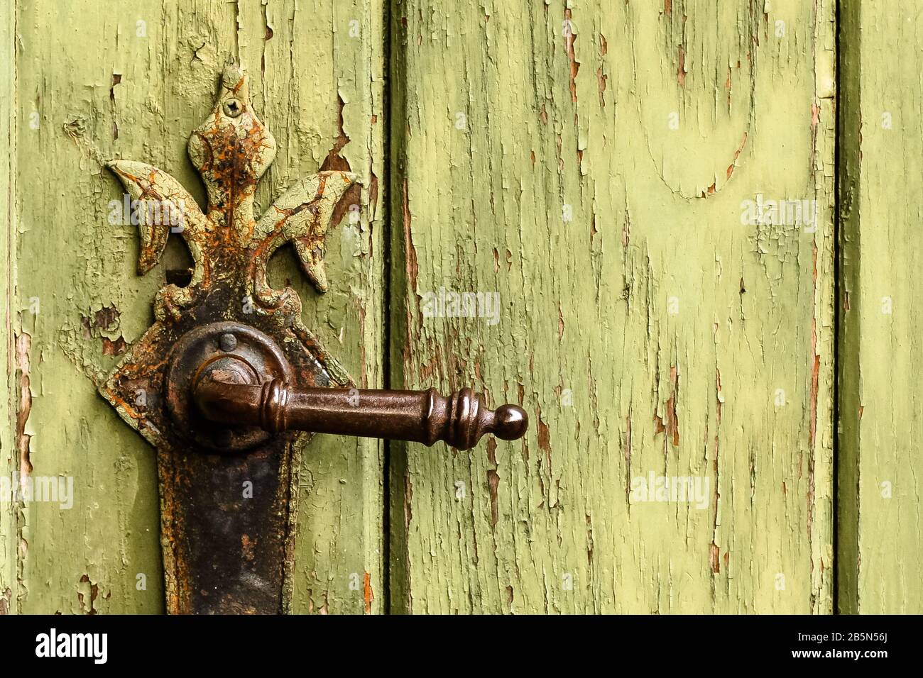 Old rusty door handle on green door. Detail of rustic old vintage and ...