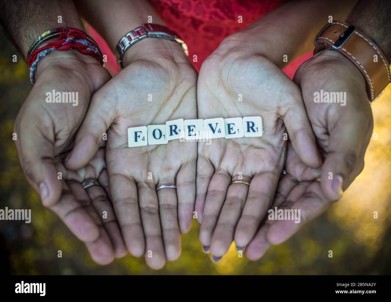 Two couples holding the words Forever Stock Photo - Alamy