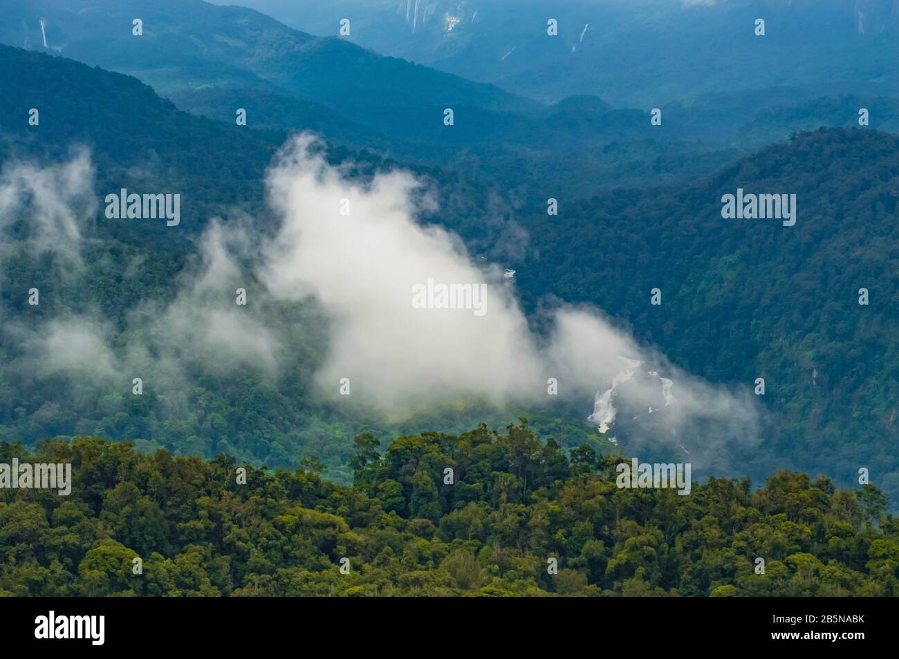 Clouds soaring up high from the water falls down Stock Photo - Alamy