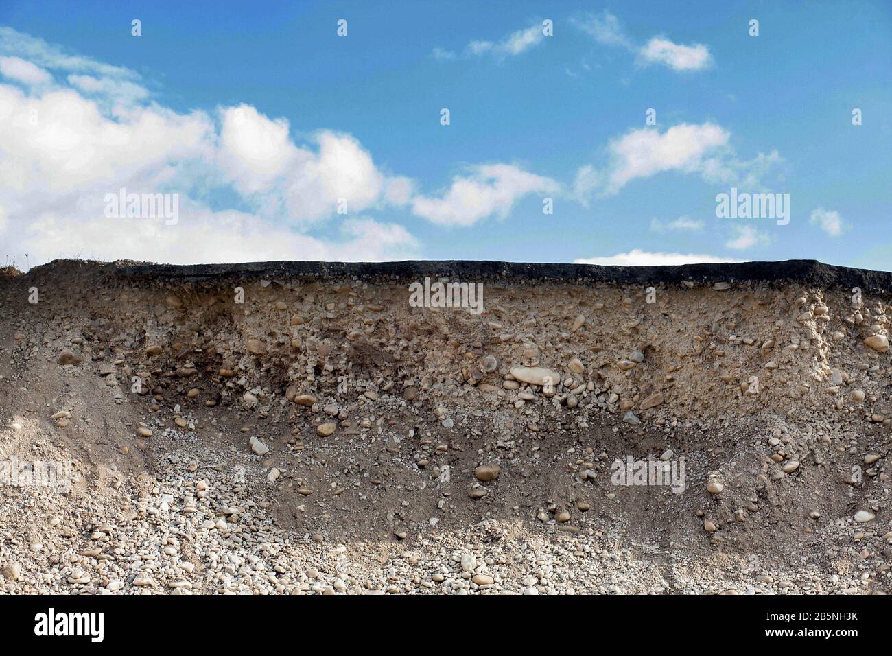 Cross section of asphalt road with blue sky background Stock Photo - Alamy