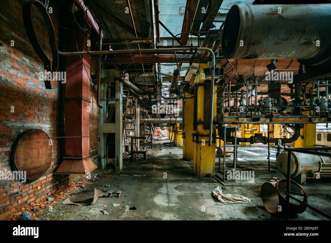 Old rusty Industrial tanks connected by pipes connected with valves in ...