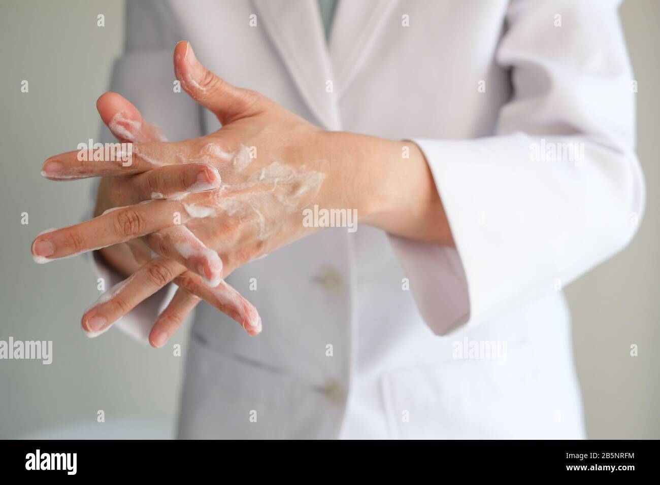 doctor wash hands with the foam soap to clean virus, bacteria and germ ...