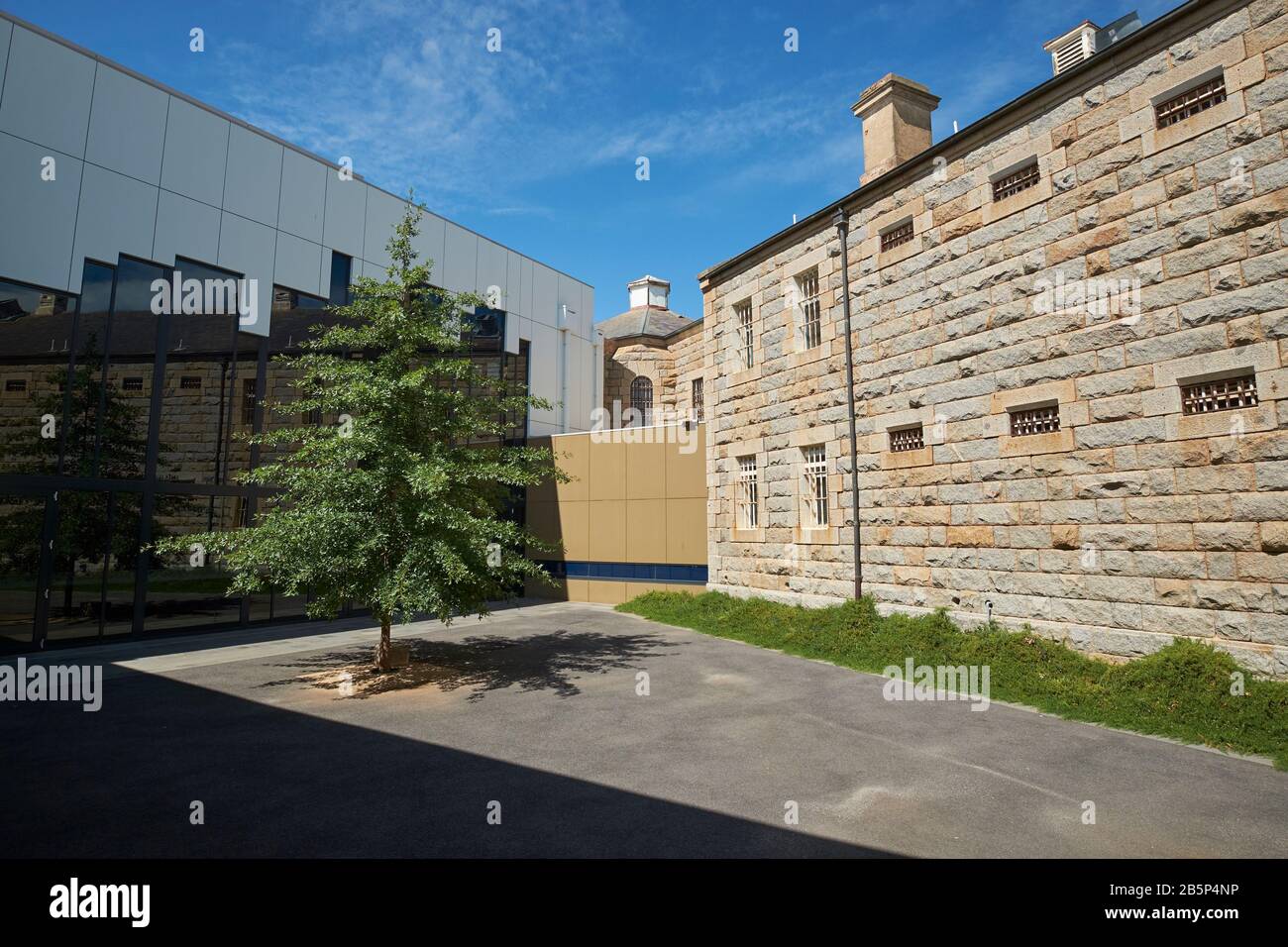 A courtyard showing the old and new buildings of the Ulumbarra Theater ...