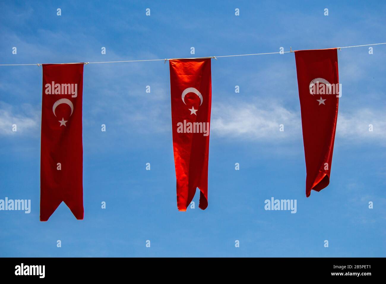 Turkish national flags with white star and moon in sky Stock Photo - Alamy