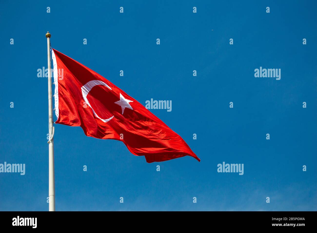 Turkish national flag with white star and moon on a pole in sky Stock ...