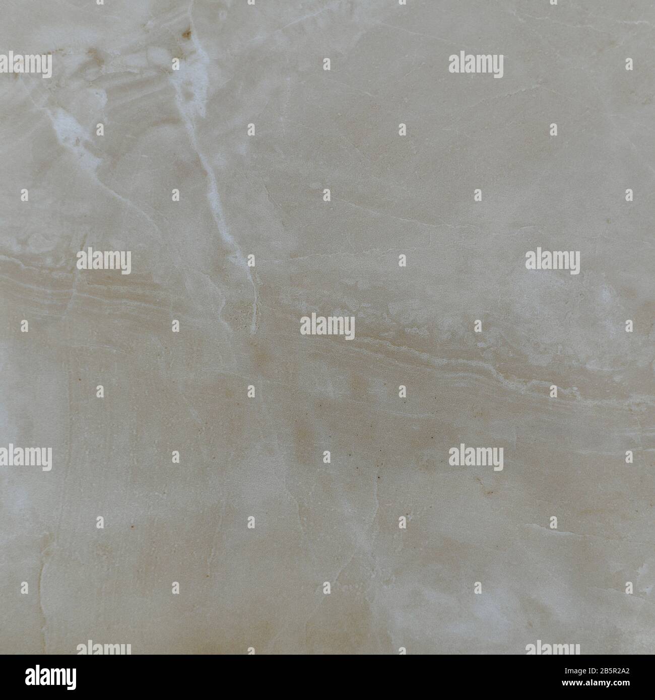 Natural beige polished marble with a sloping line dividing the frame in ...