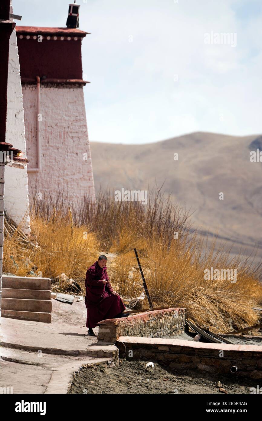 Monk hunting for cell phone signal, Samding Monastery, Tibet Stock ...