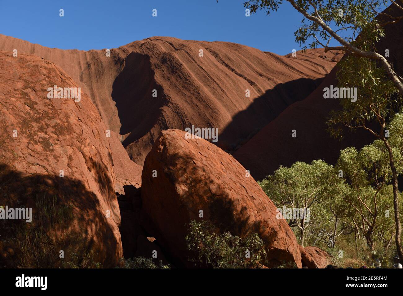 Profile of ULURU with large boulders weathered rock creases and a line ...