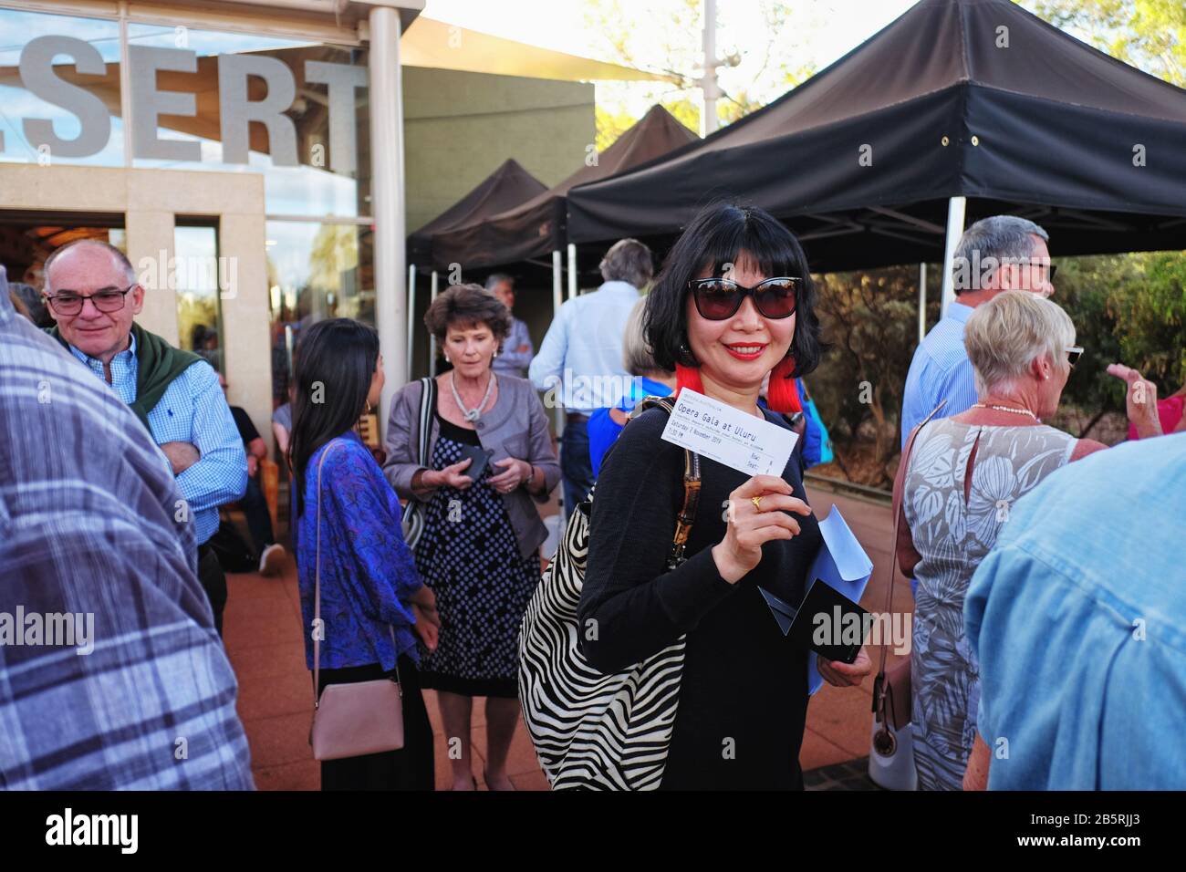 Woman with ticket for Opera in the Outback at Uluru, Under The Outback ...