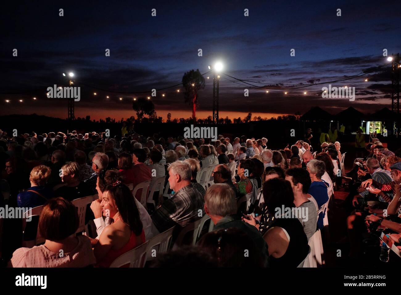 The seated audience at dusk for an outdoor night of music with the real ...