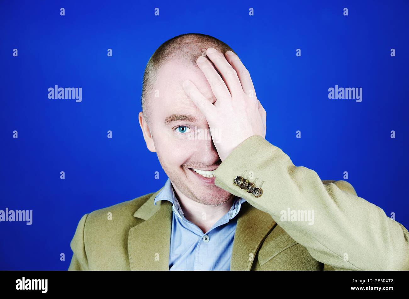 Facepalm. Gaze of happy smiling joyful man who covering his face. Shame ...