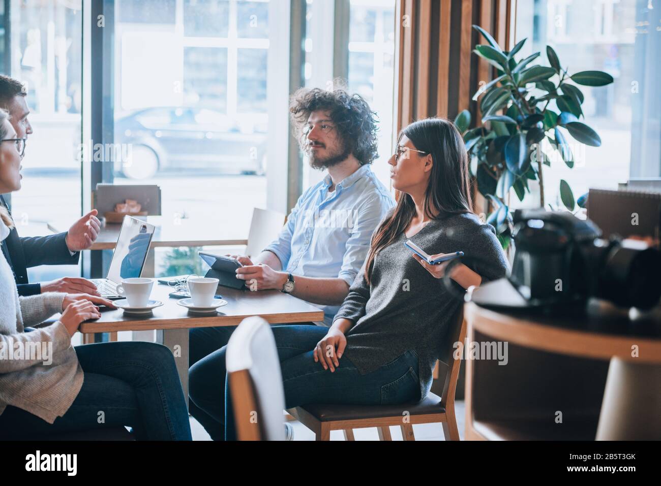 Young attractive people having a pleasant conversation about work at a ...