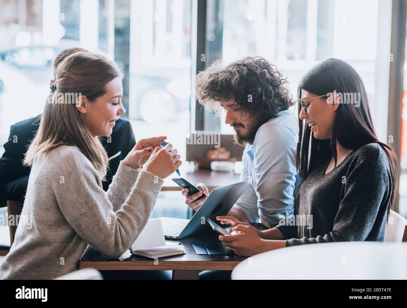 Group of coworkers during a brainstorming session at a coffee shop ...