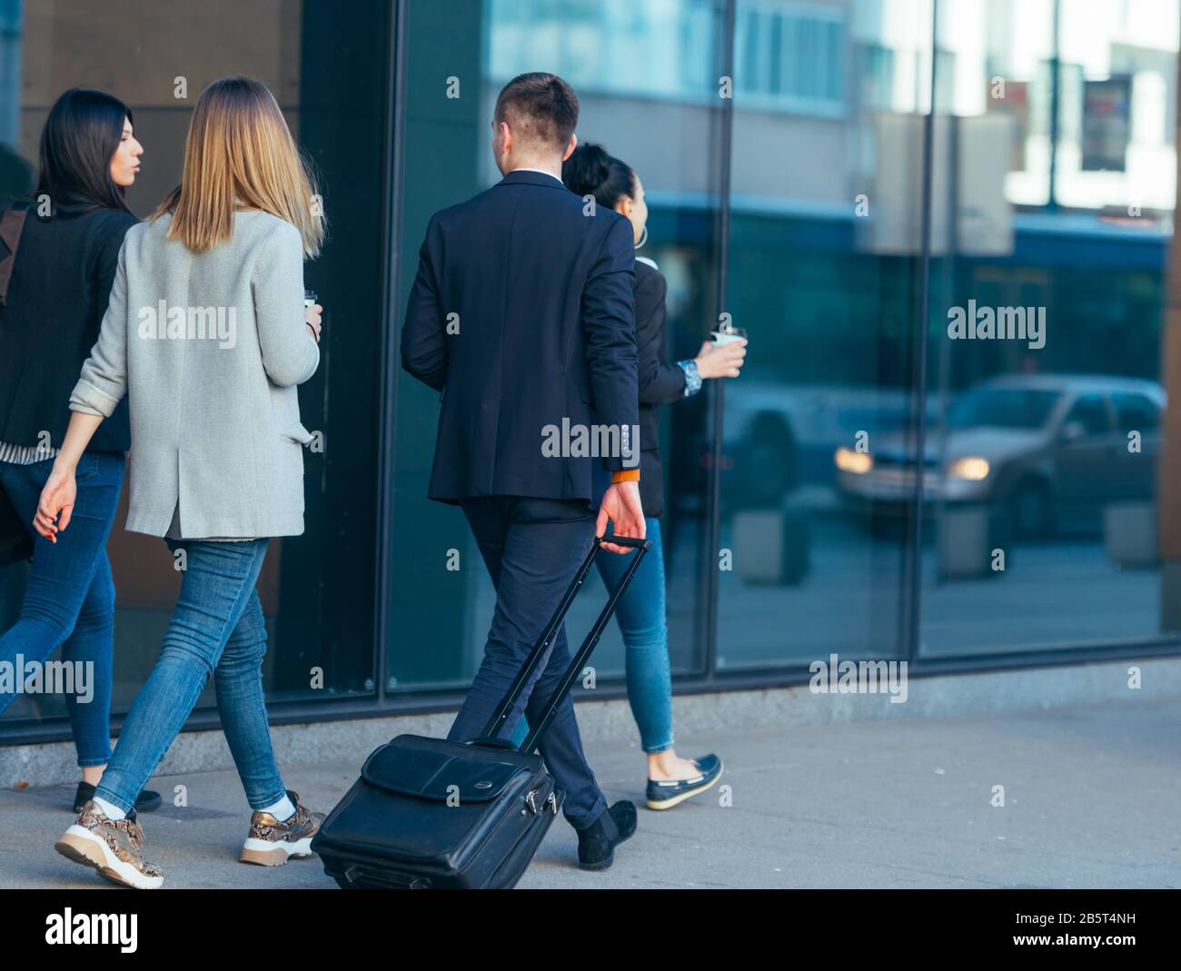 Group of colleagues on a business trip (euro trip) walking together at ...