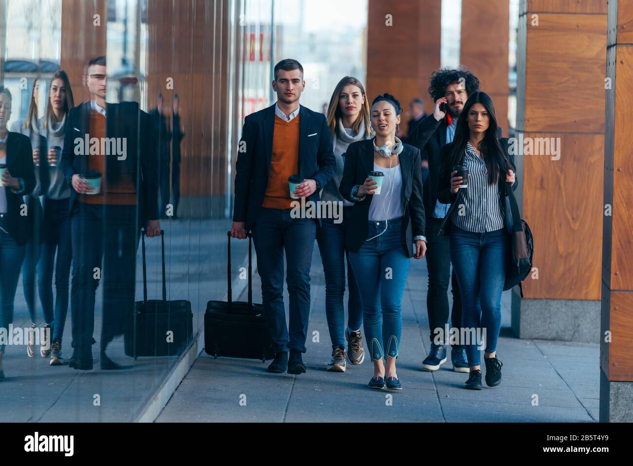 Group of colleagues on a business trip (euro trip) walking together at ...