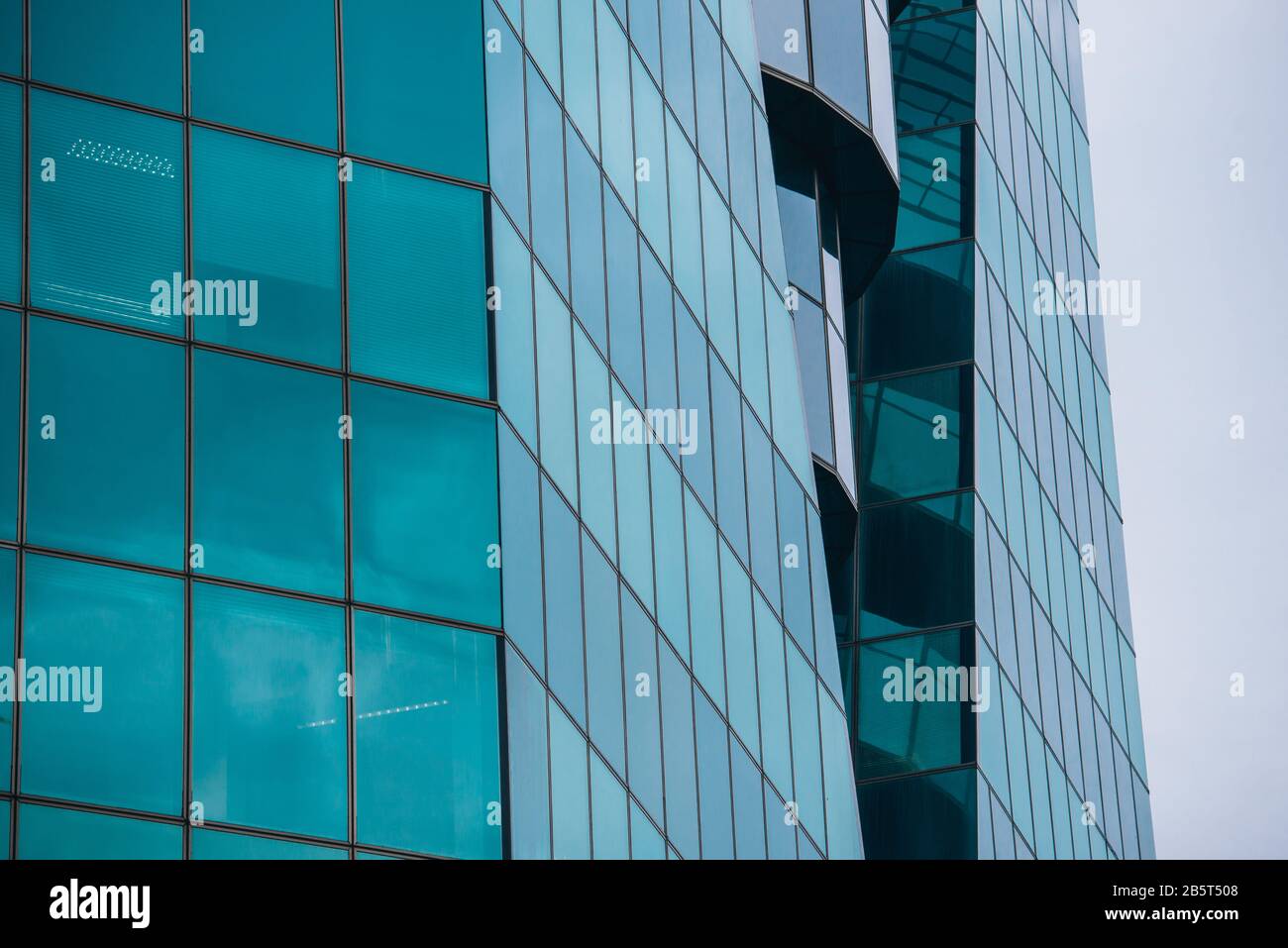 Blue glass reflective windows of a modern office building Stock Photo ...