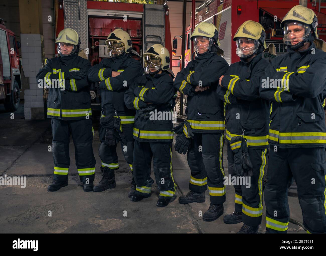 Group of firefighters standing confident with arms crossed. Firemen ...