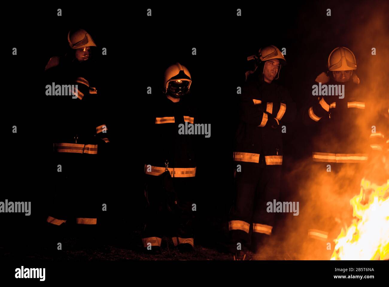 Fire brigade fighting a forest fire with various tools for eliminating ...