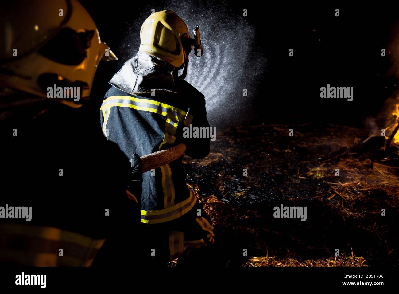 Fire brigade during operation in the field at night time Stock Photo ...