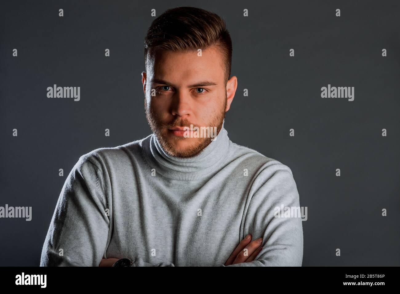 Studio body shot of a trendy young man wearing modern style clothes ...