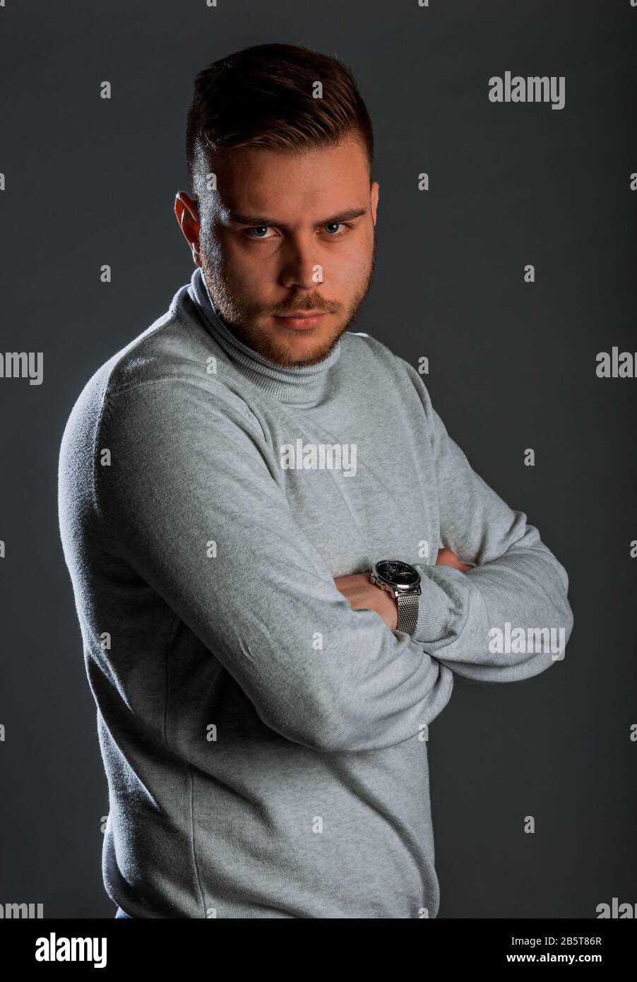 Body shot of an attractive male model posing in modern stylish sweater ...