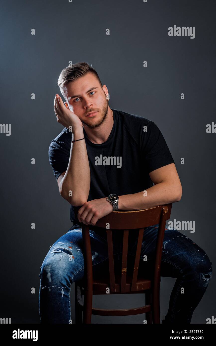 Studio body shot of a trendy young man wearing modern style clothes ...