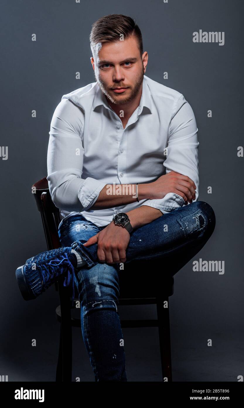 Body shot of an attractive male model posing in modern stylish sweater ...