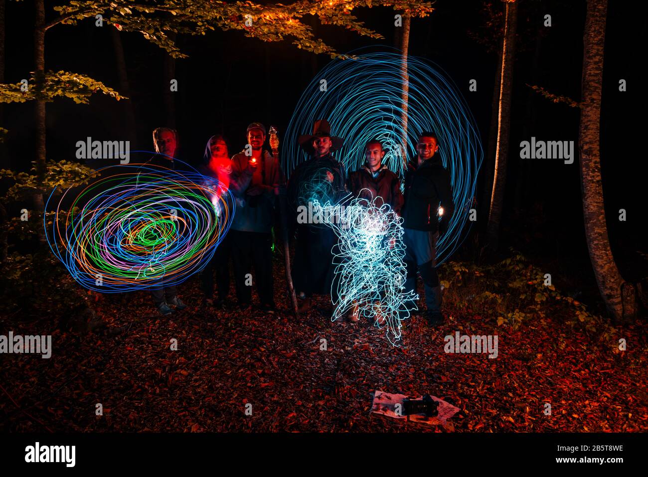Wizard (mage) casting a spell with his magical staff while standing in ...