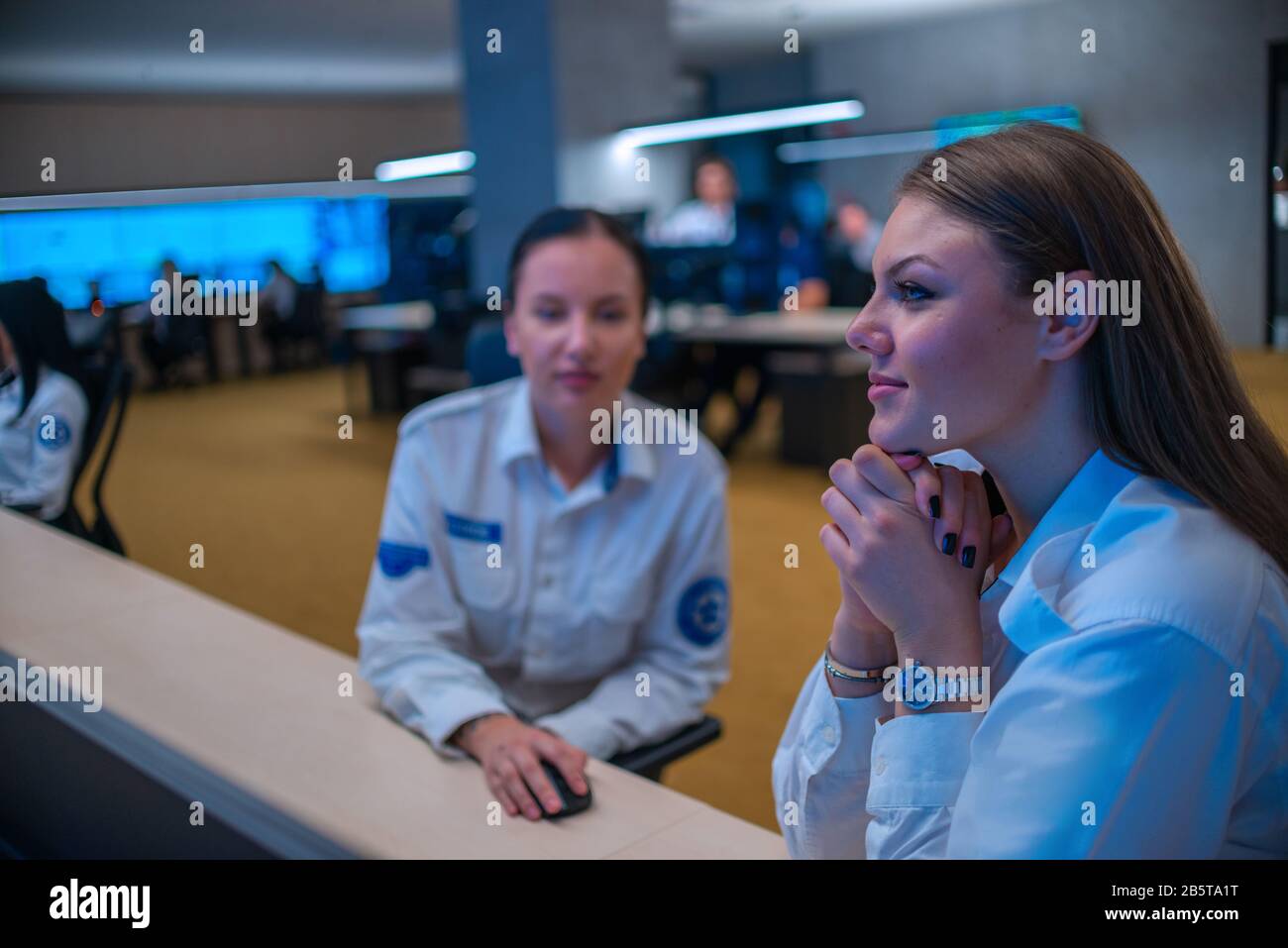 Close up photo of a security female agent monitoring the CCTV in a main ...
