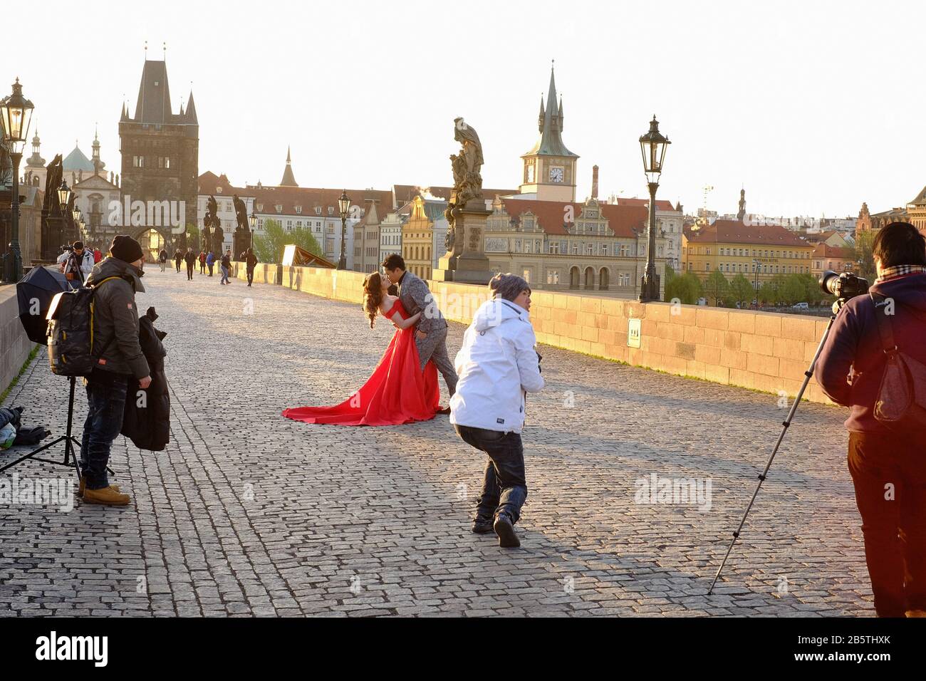 Asian wedding shoot on the Charles Bridge Prague at daybreak, with the ...