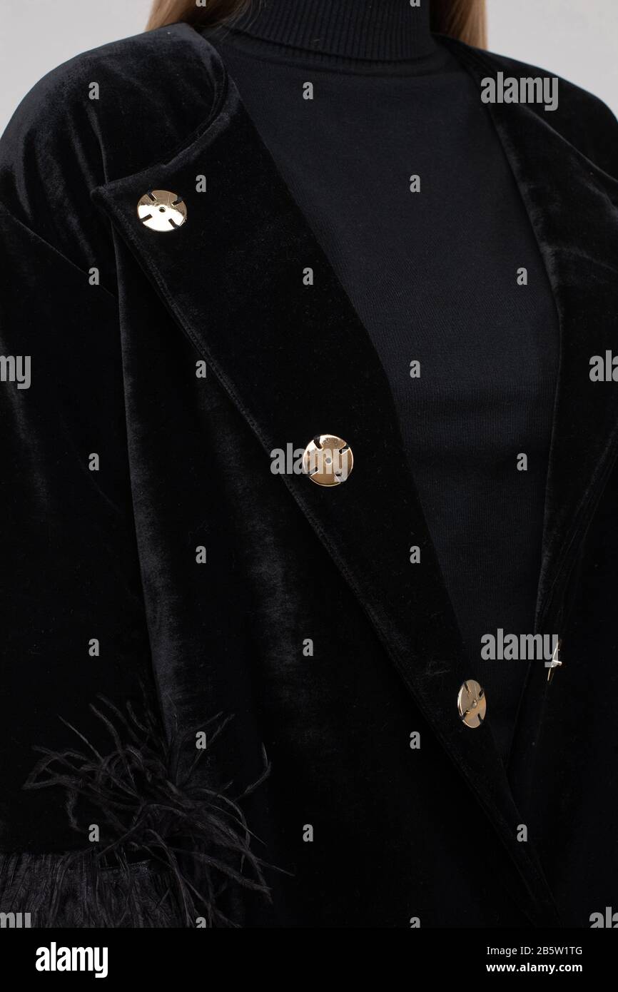 Crop of a model in fashionable black coat Stock Photo - Alamy