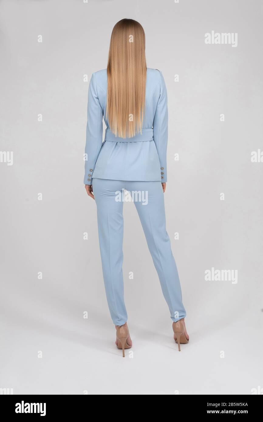 Back view of blonde model in light blue suit Stock Photo - Alamy
