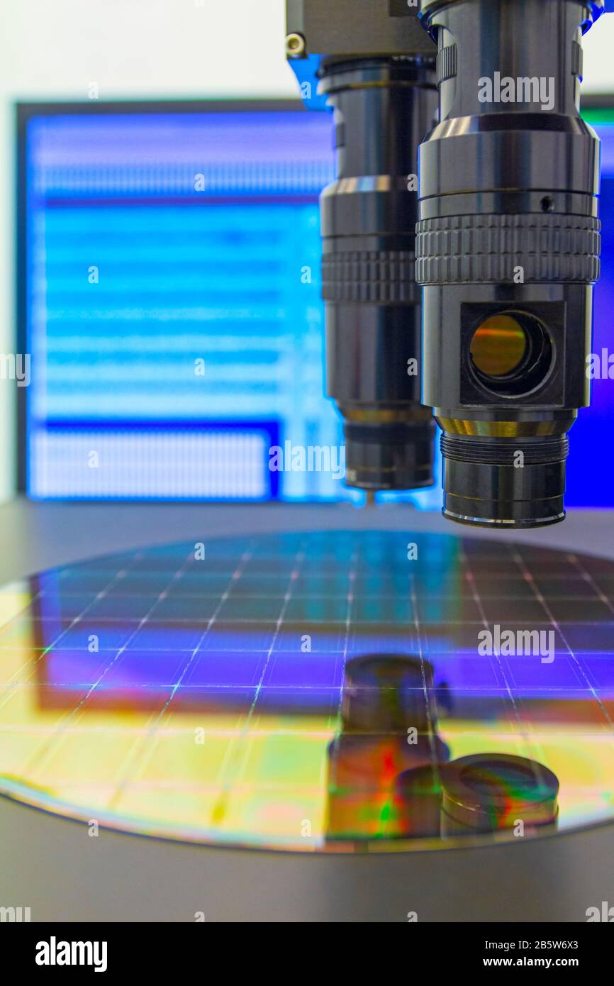 Silicon wafer with semiconductor microchip on machine process examining ...