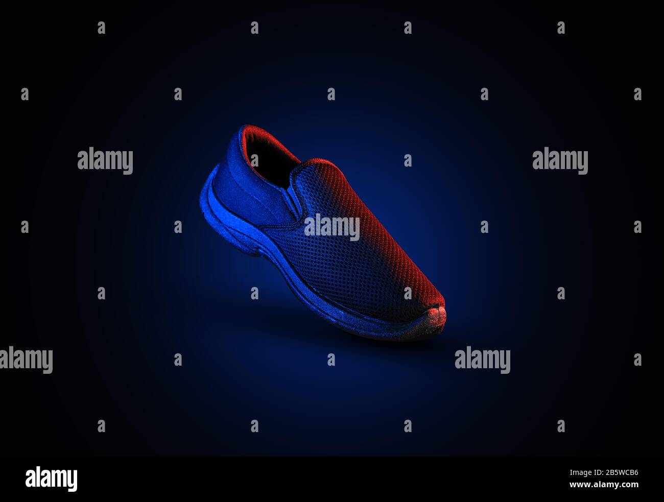 Dramatic shoe photo with blue and red light on dark background Stock ...