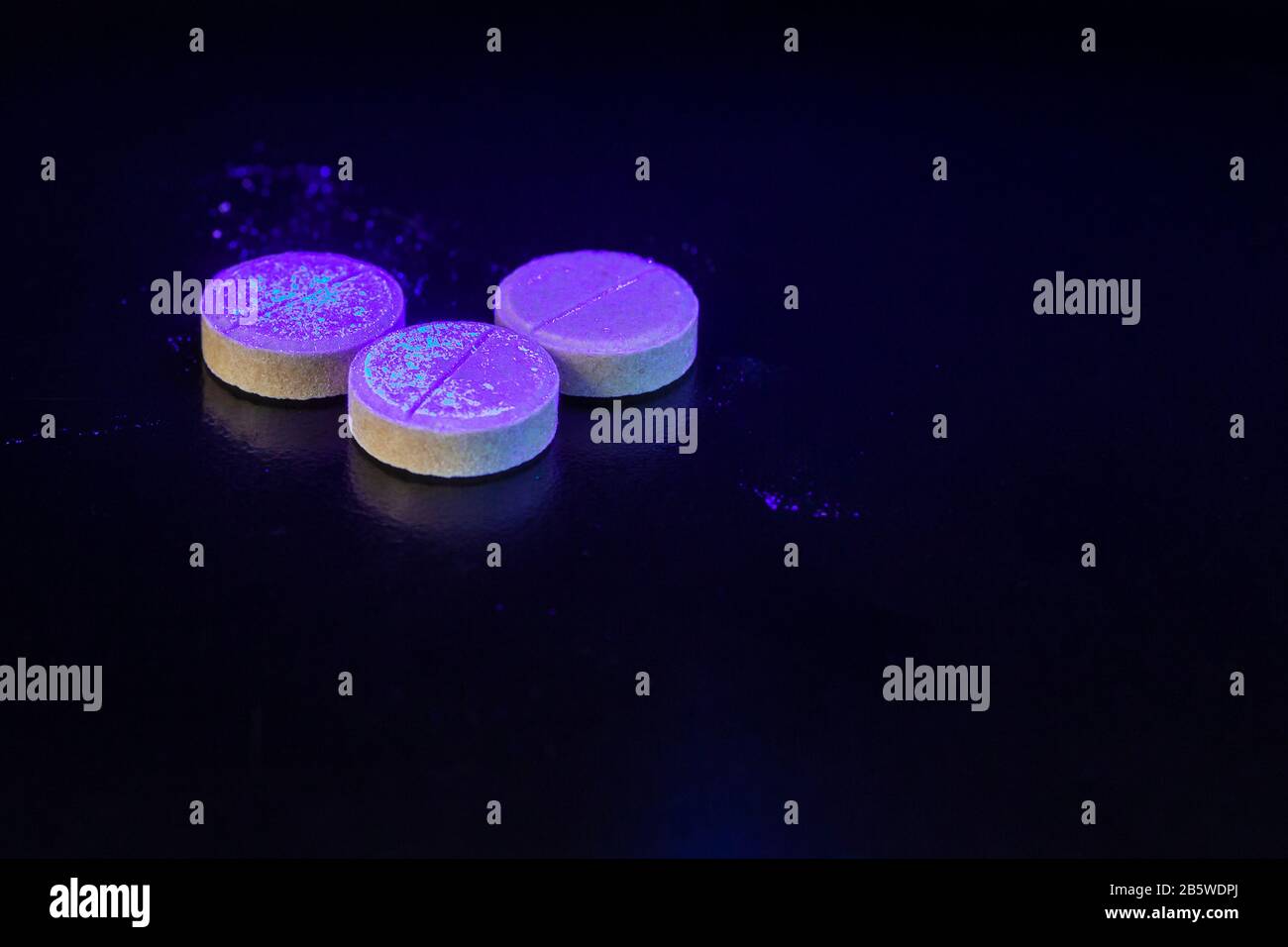 Medicine tablets and pill on UV Light.Selective focus Stock Photo - Alamy