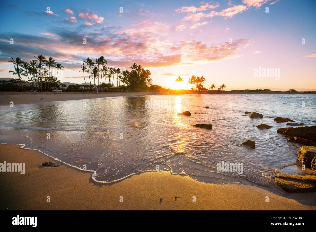 Amazing hawaiian beach. Wave in ocean at sunset or sunrise with surfer ...