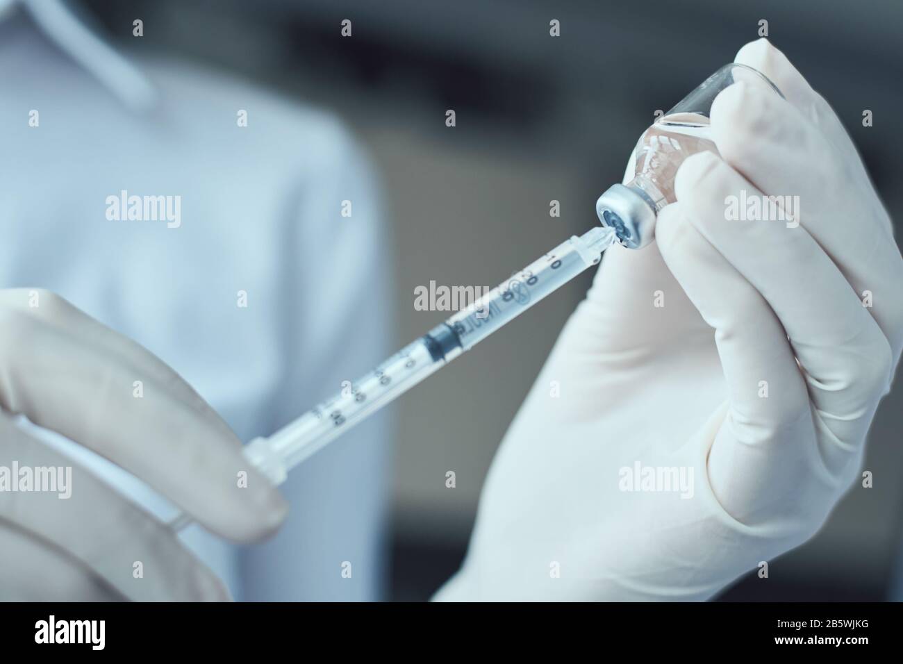 Woman hold an injection syringe and medicine vial ampoule. Healthcare ...