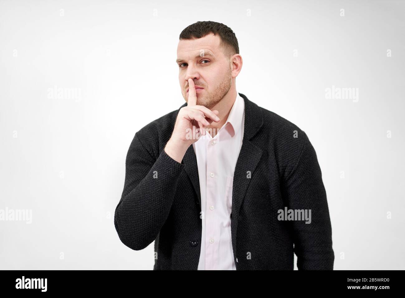 Man finger mouth saying quiet hi-res stock photography and images - Alamy