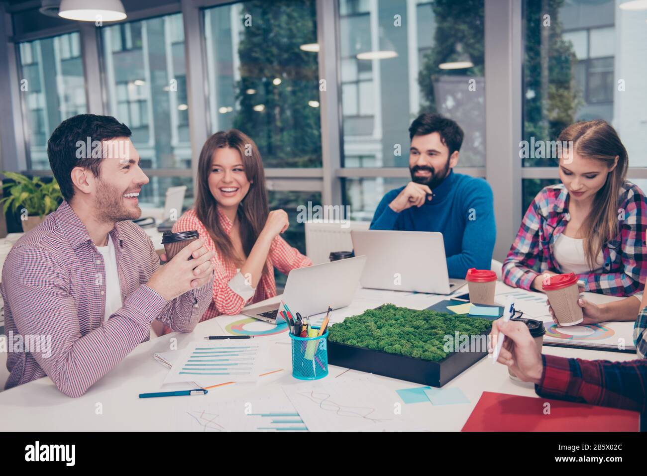 Group of students talking about future project and laugh, sitting on ...