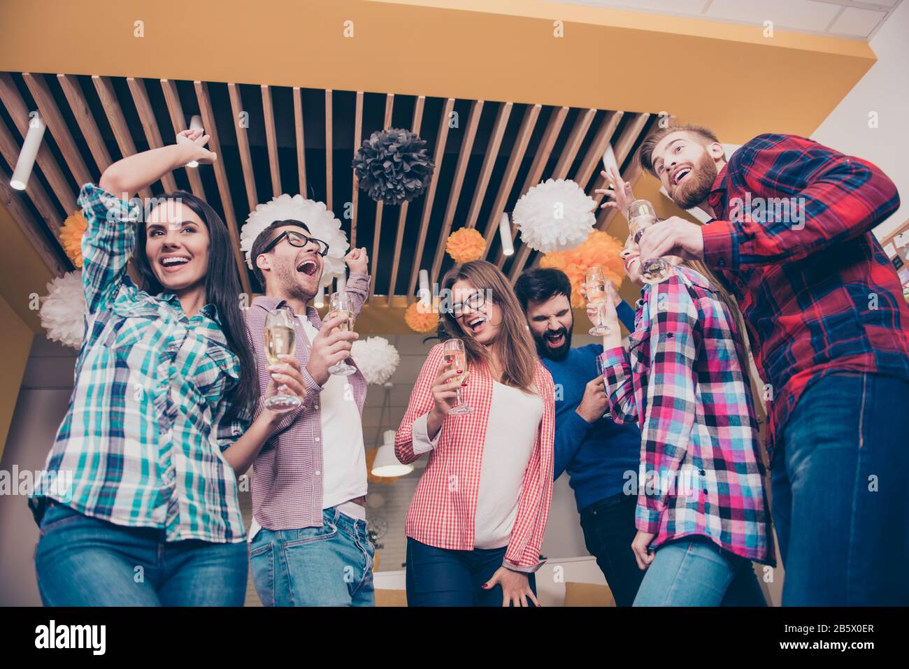 Party time. Six attractive happy laughing friends, boys and girls ...