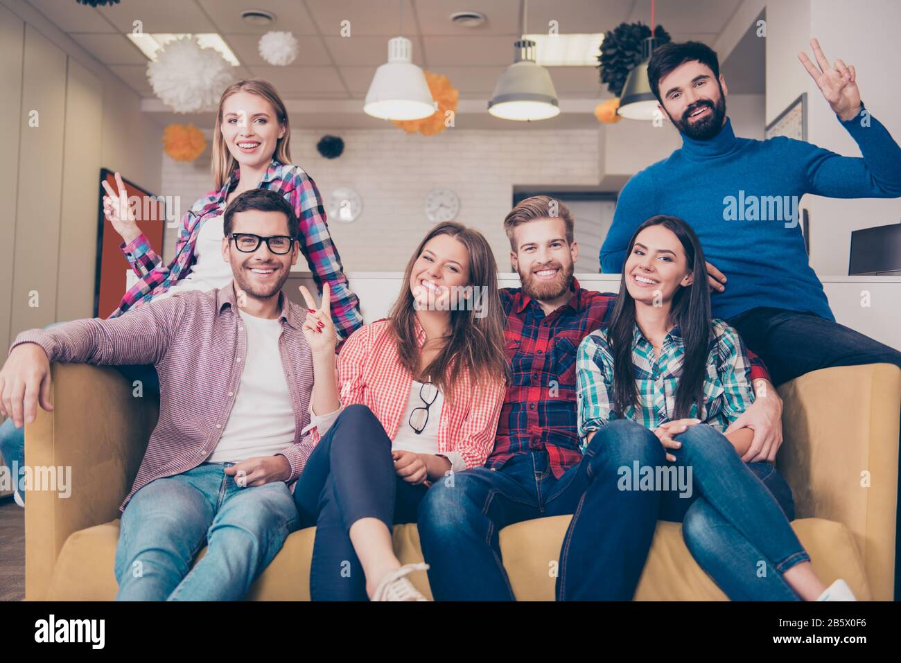 Portrait of six young happy smiling best friends sitting on couch Stock ...